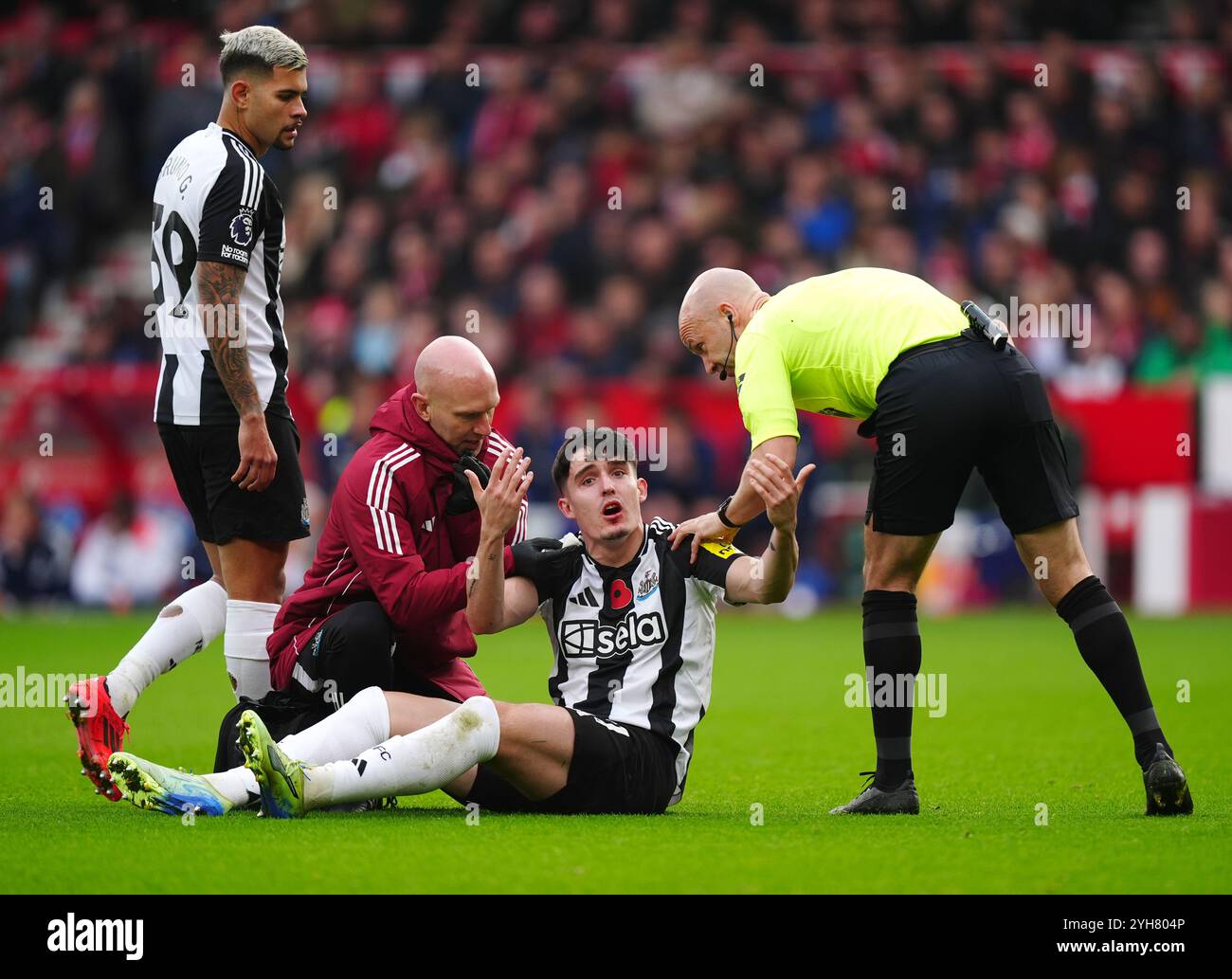 Newcastle United's Tino Livramento reacts after being injured following ...