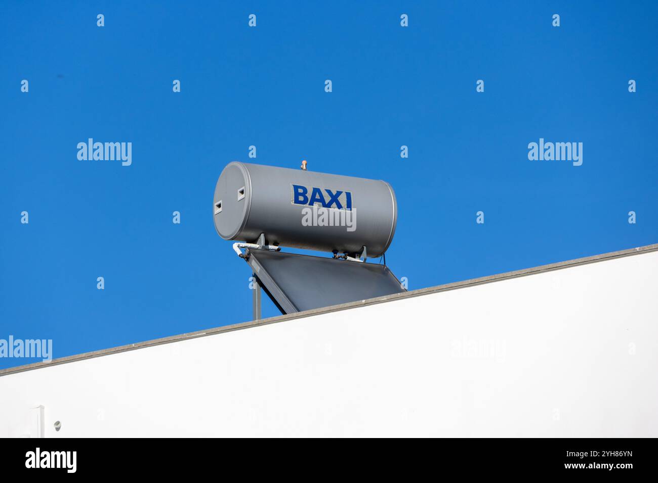 Solar thermal panel and baxi boiler are installed on a white rooftop ...