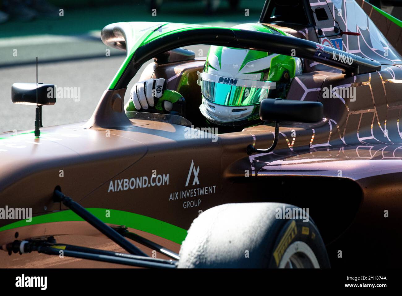 Race car driver driving a formula car on a race track, wearing helmet ...