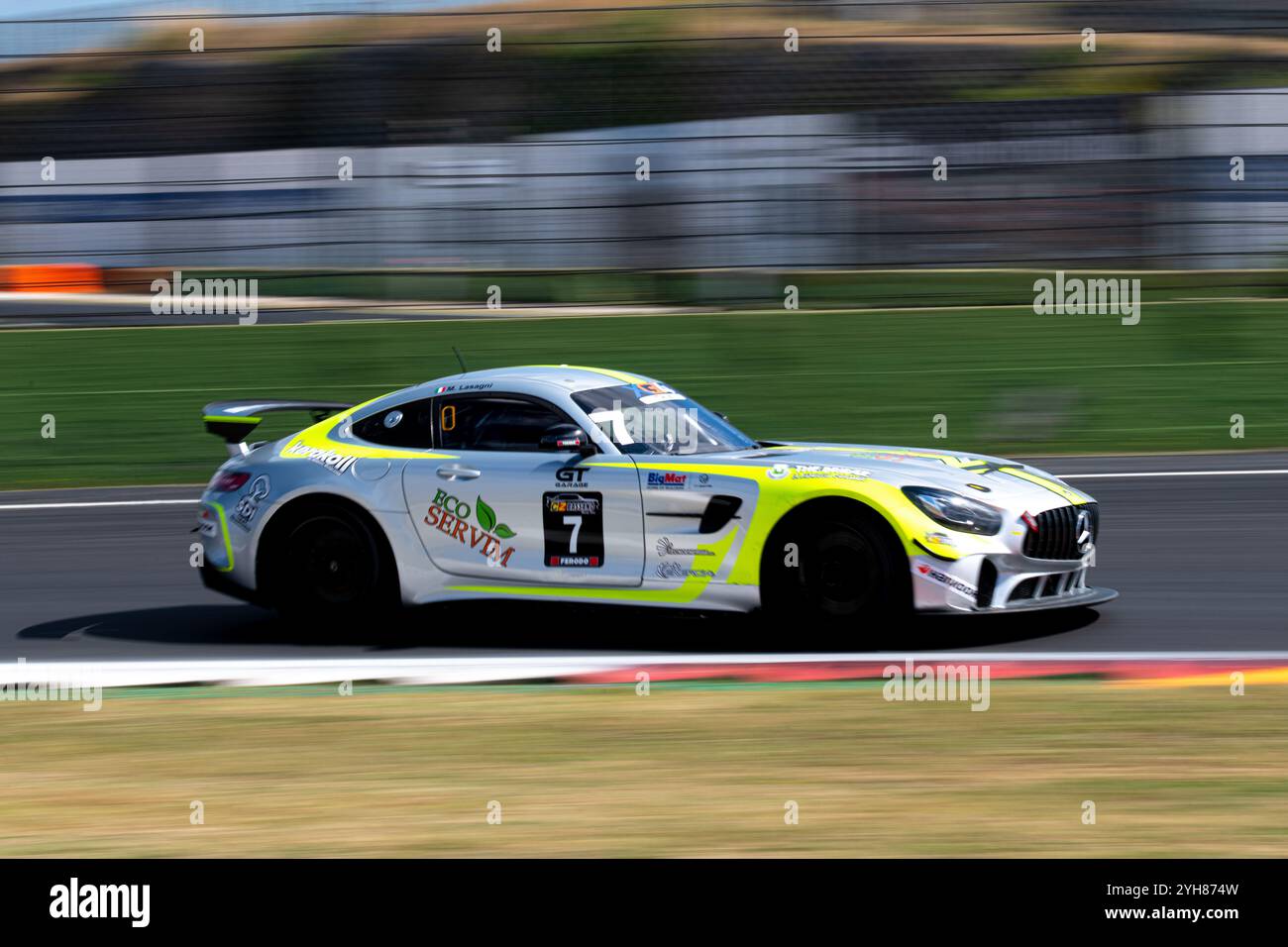 Silver mercedes amg gt3 racing car speeding on a racetrack during a ...