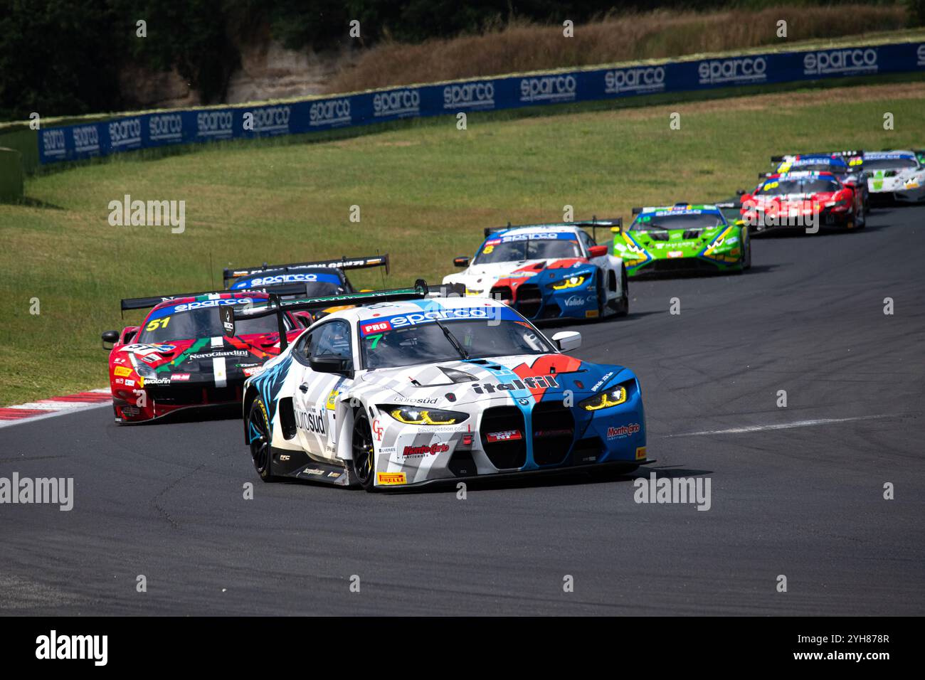 Bmw m4 gt3 race car leading a pack of gt cars during a motorsport ...