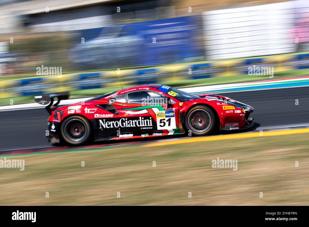Red ferrari 488 gt3 evo speeding on a race track during a motorsport ...
