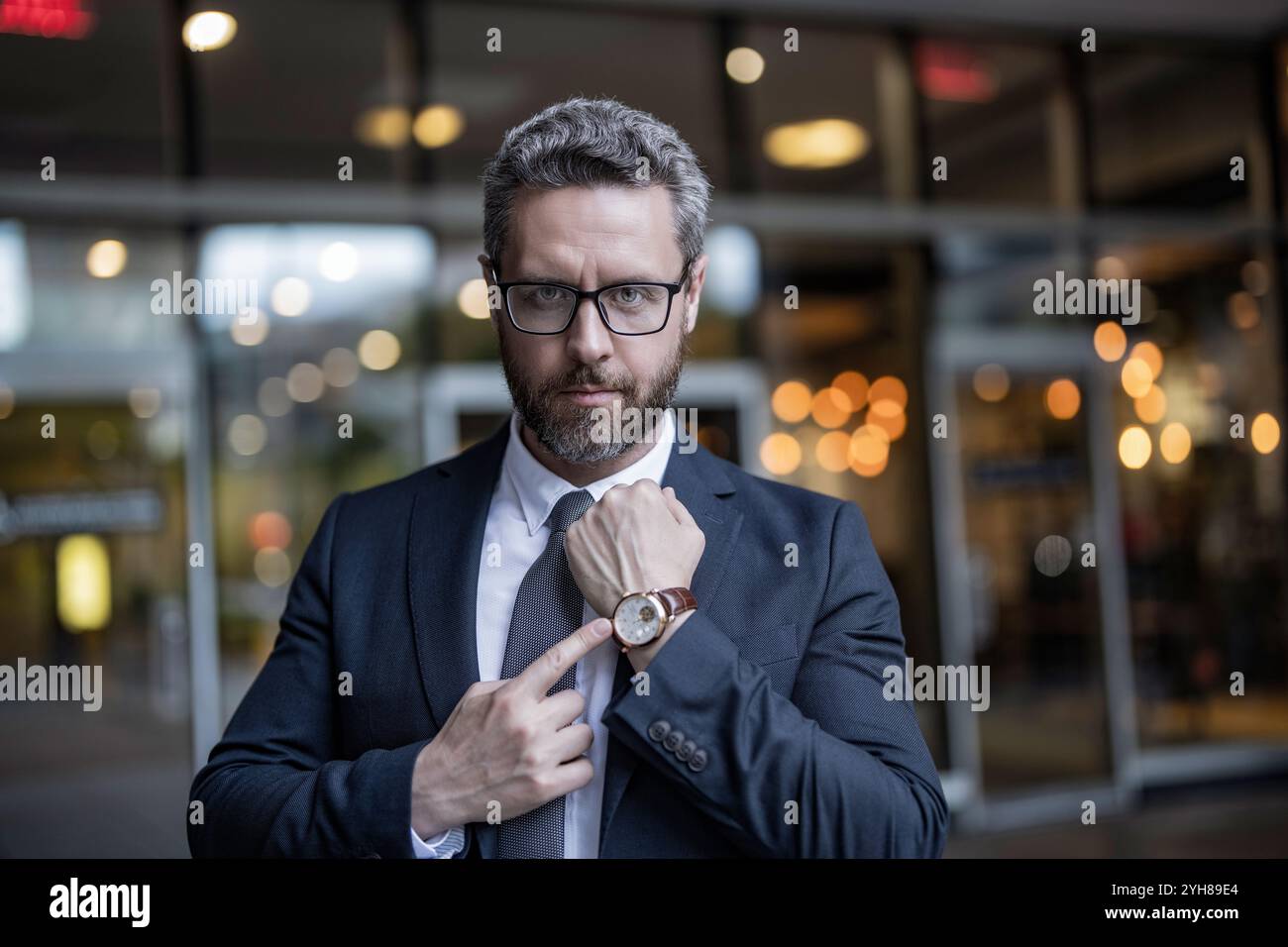 Time management. Punctual man point finger on time on watch ...