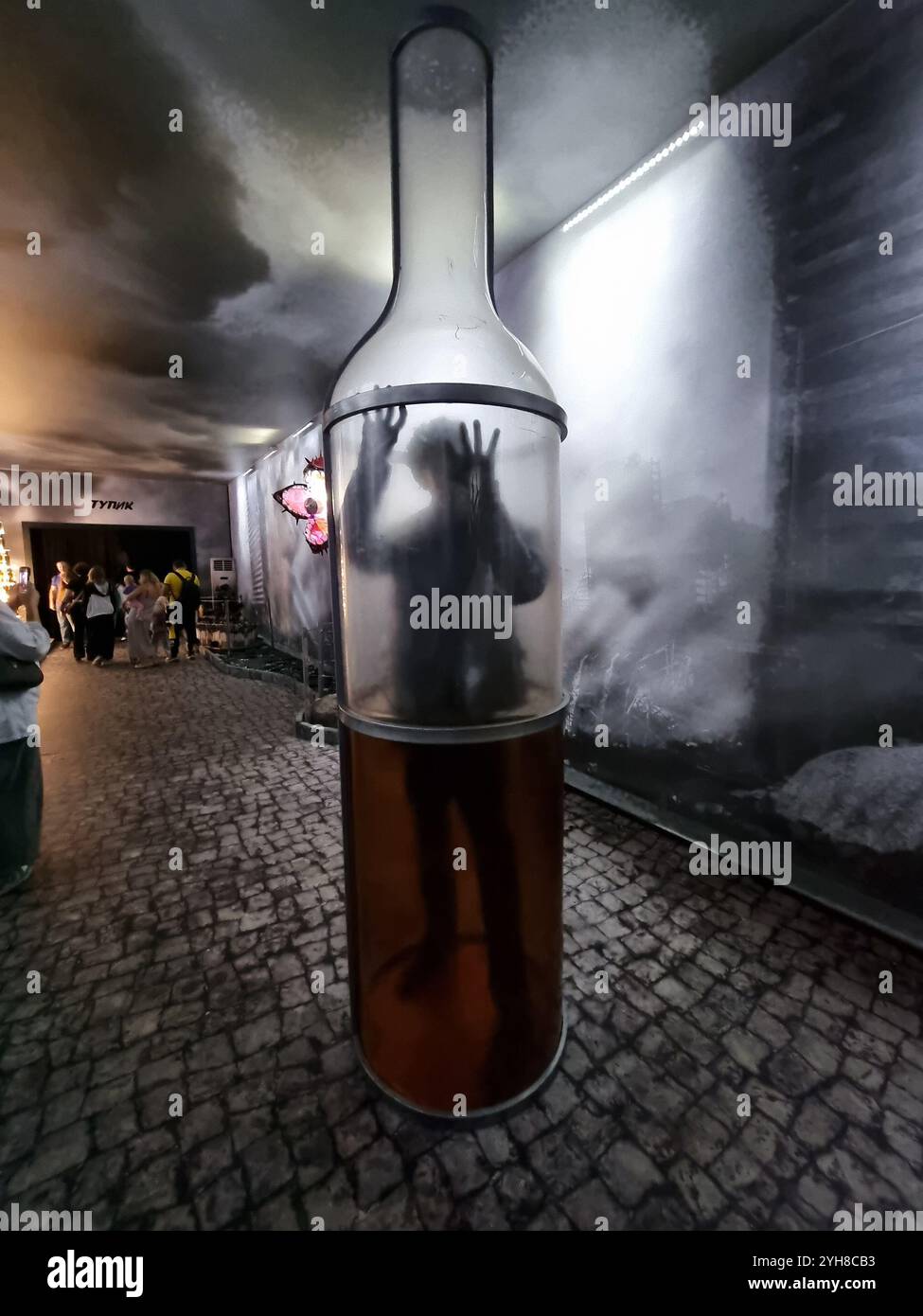 Human figure in a large bottle, trying to escape; showing concept of ...