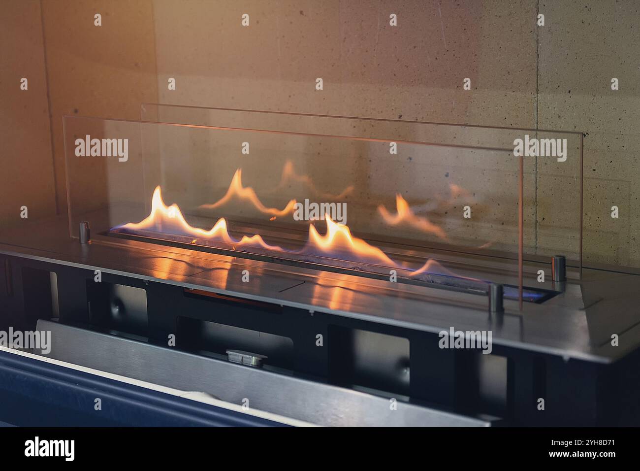 Fire burns in a modern fireplace. Interior Stock Photo - Alamy