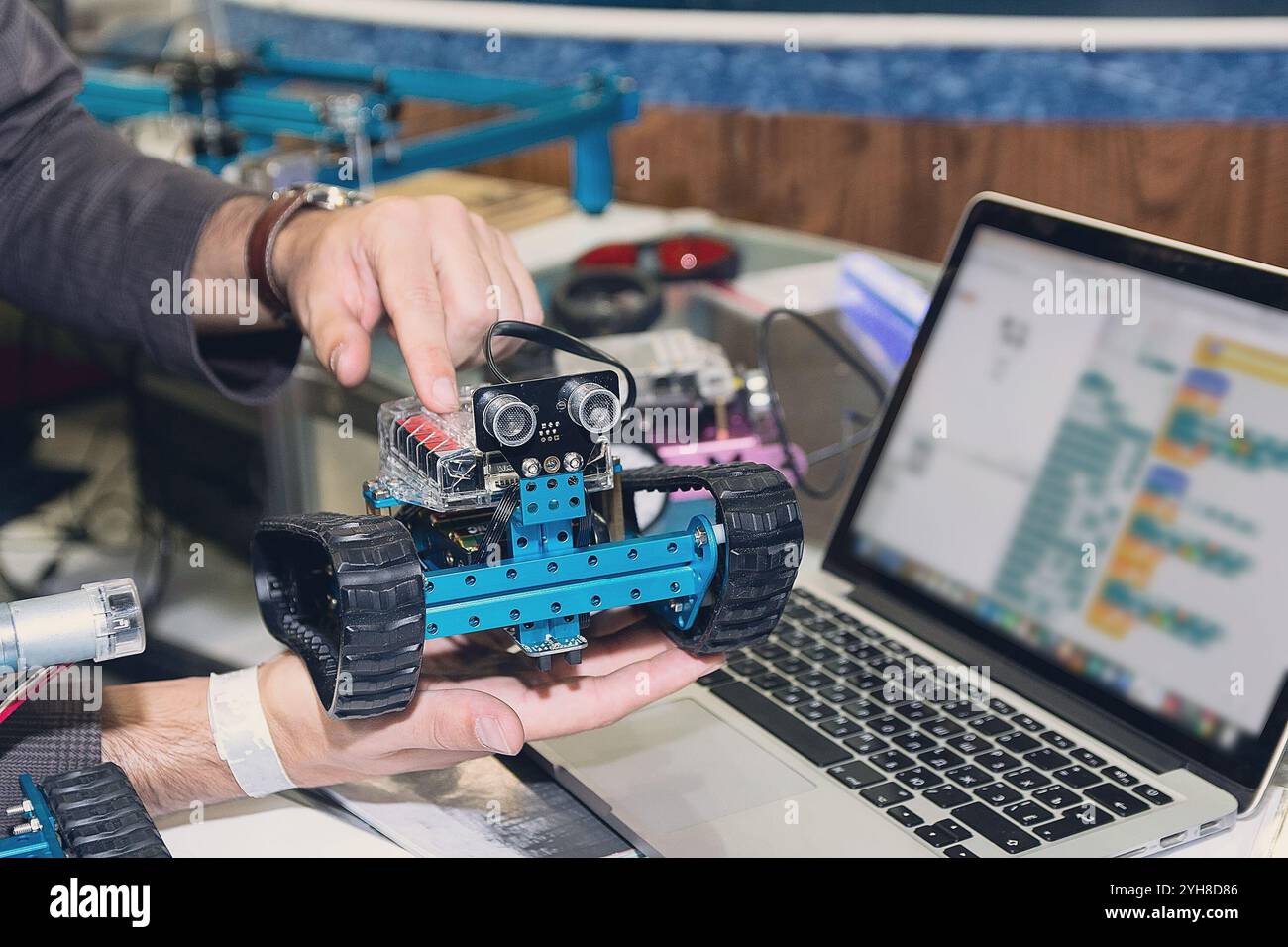 Model of a robot in the hands of a teacher during a robotics lesson. Diy Stock Photo - Alamy