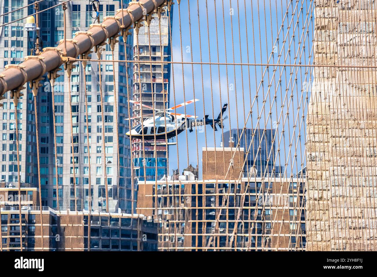 NYPD helicopter flying over Brooklyn bridge view, New York city, USA ...