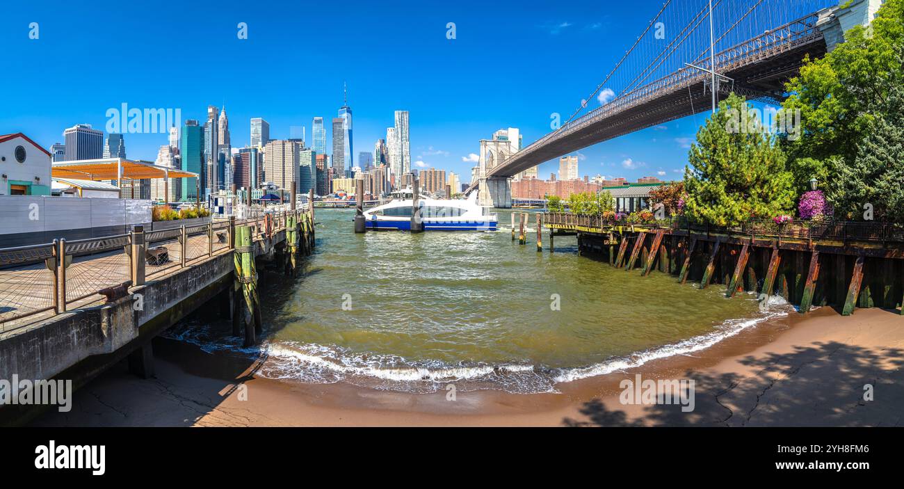 New York city Dumbo ferry pier and East river small beach under ...
