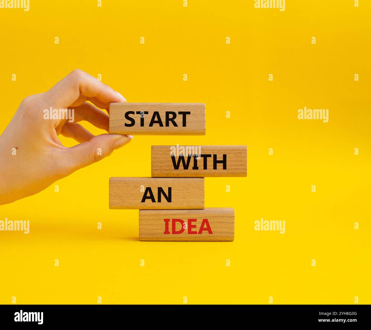 Start with an Idea symbol. Wooden blocks with words Start with an Idea ...