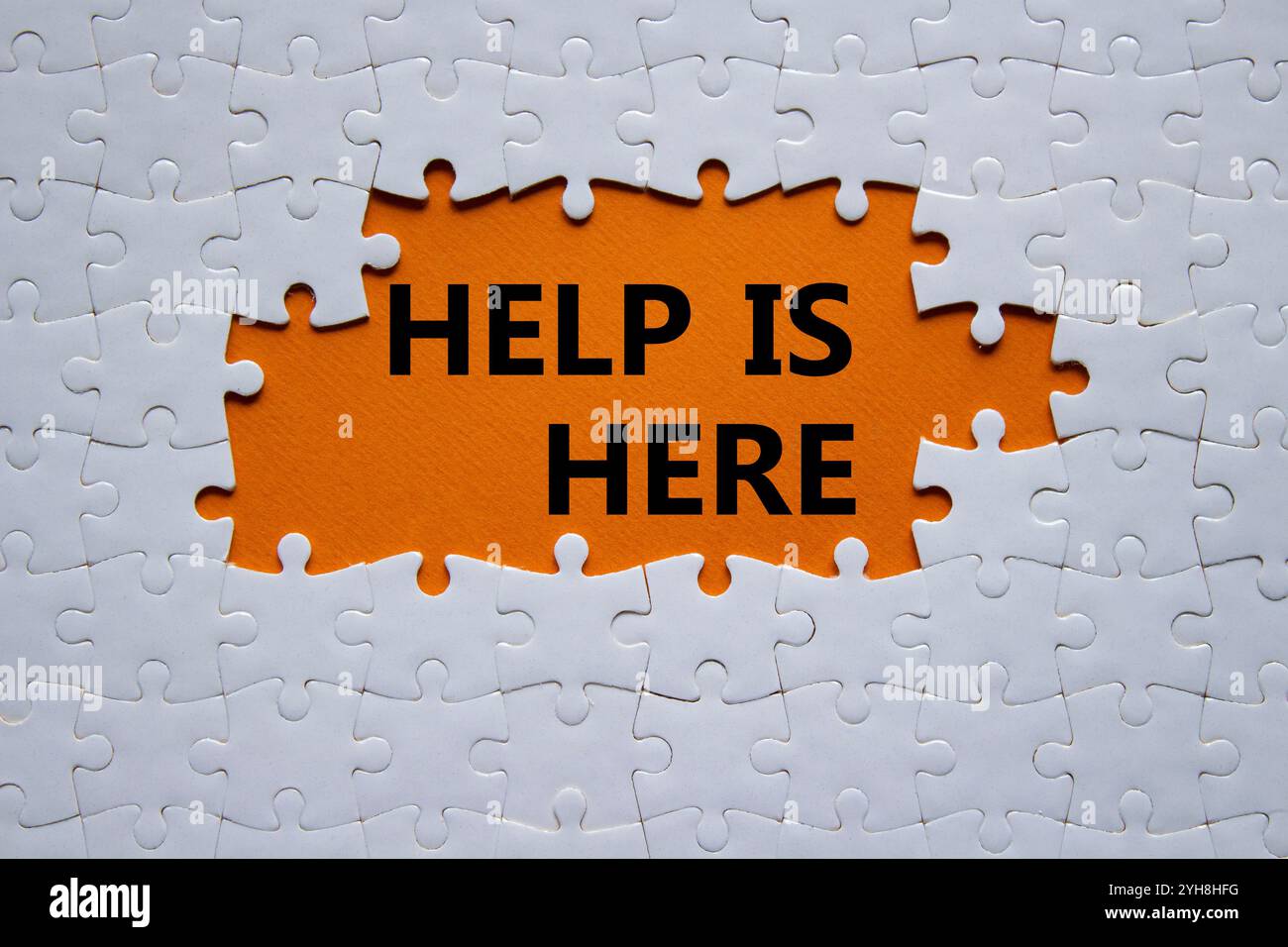 Help is here symbol. Concept words Help is here on white puzzle ...