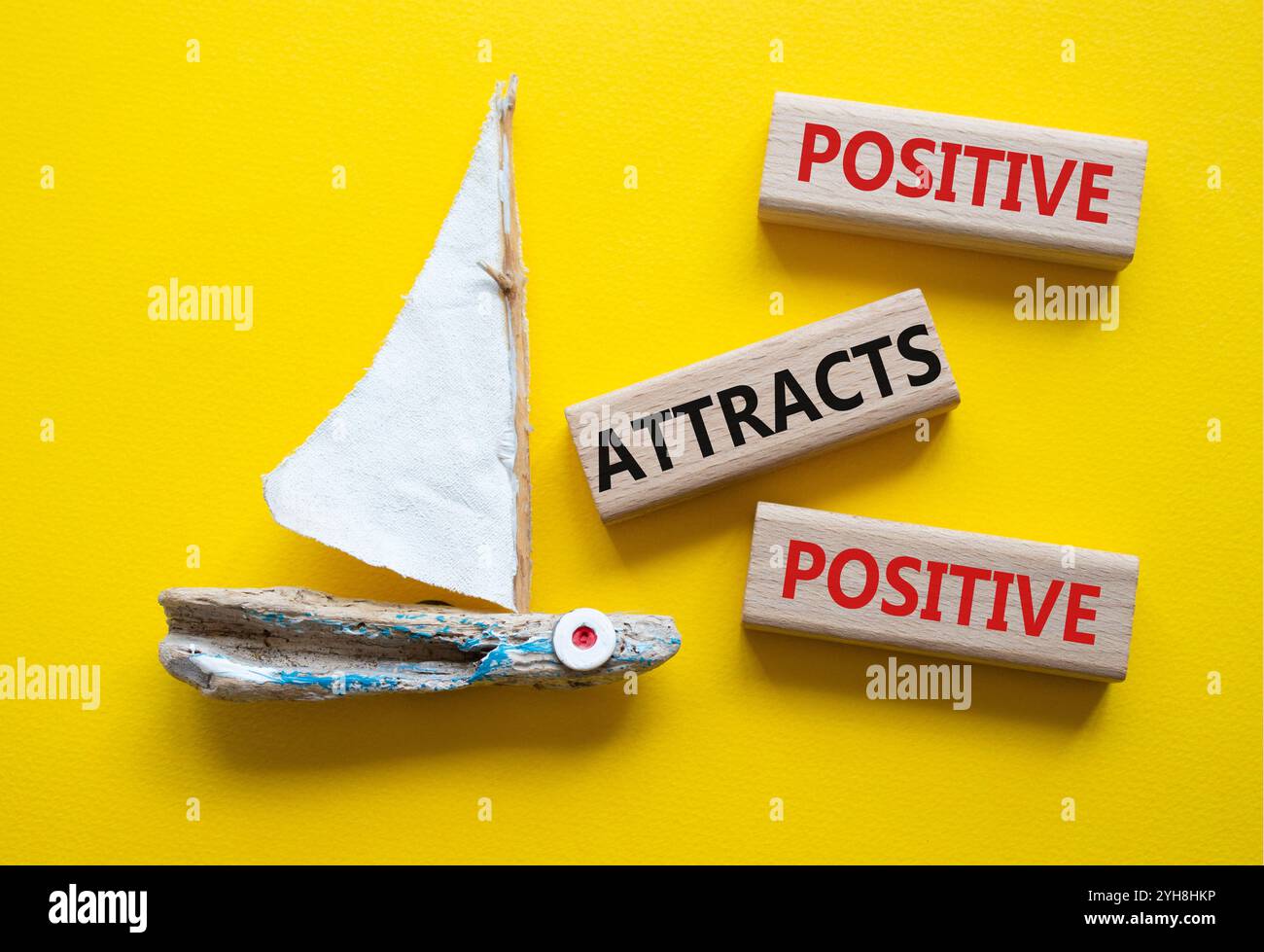 Positive attracts Positive symbol. Wooden blocks with words Positive ...