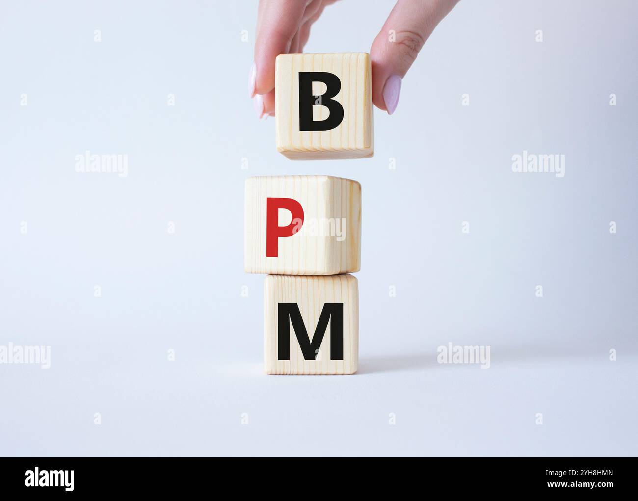 BPM - Business Process Management symbol. Wooden cubes with words BPM ...