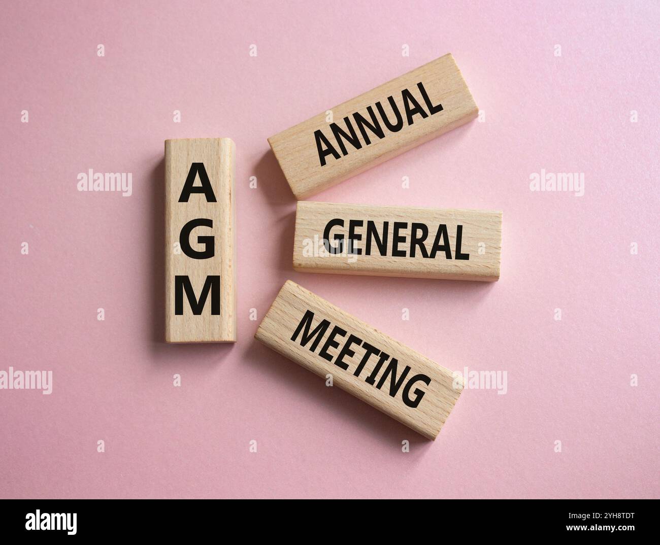 AGM - Annual general meeting symbol. Concept word AGM on wooden blocks ...