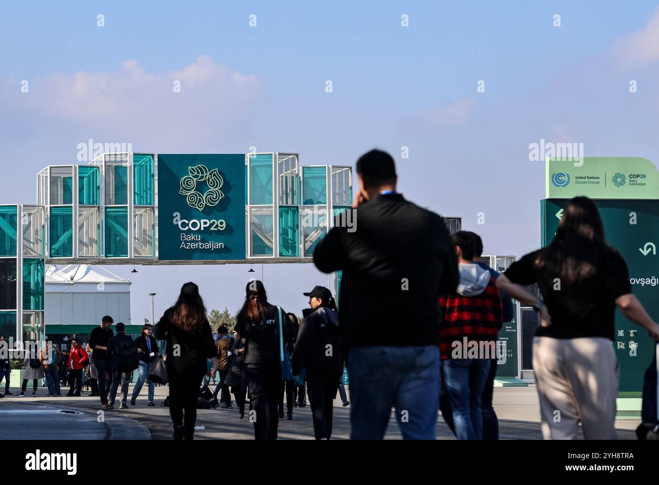 Participants walk in fron of COP29 entrance as UN Climate Change ...