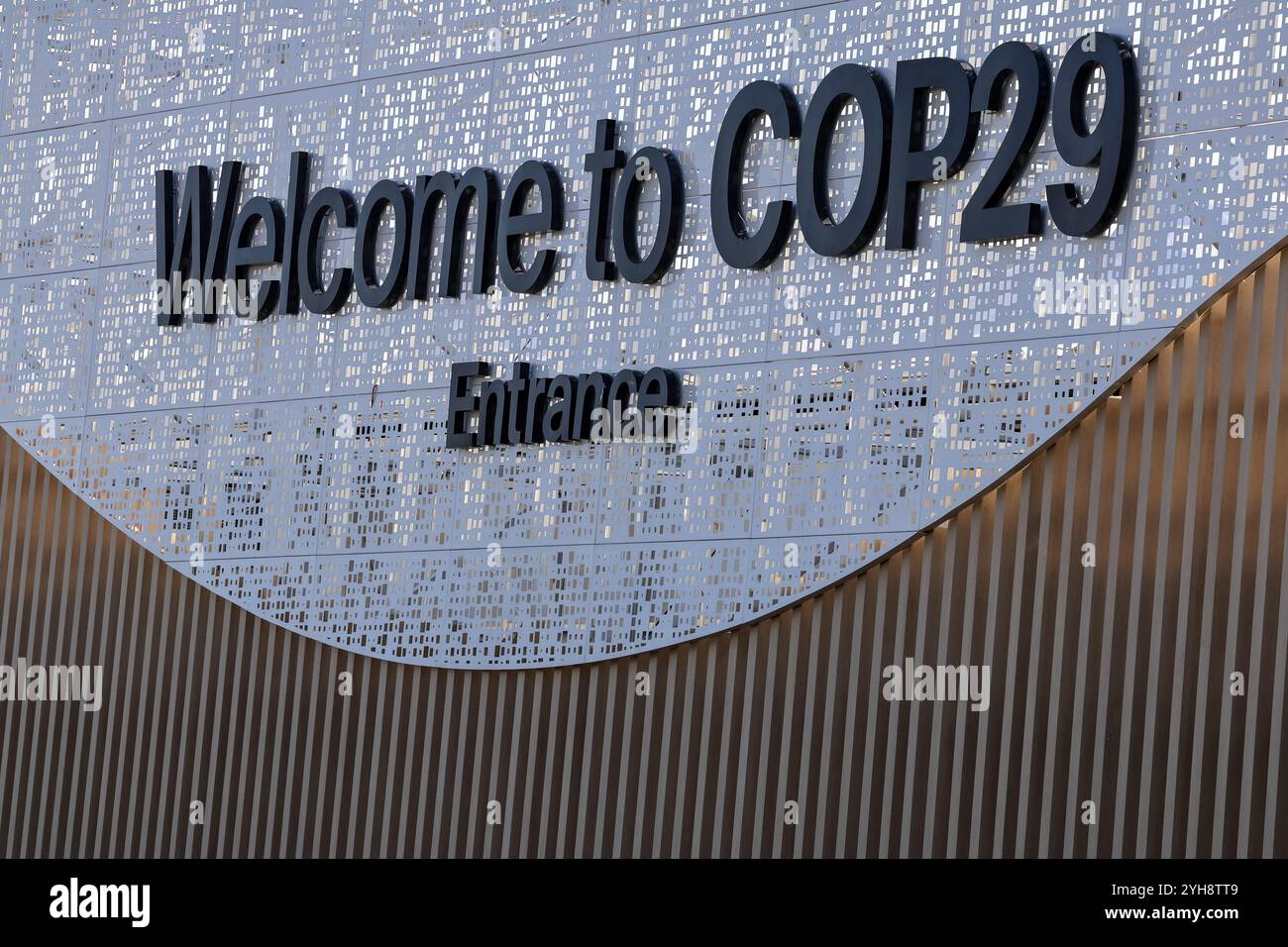 Participants walk in fron of COP29 entrance as UN Climate Change ...