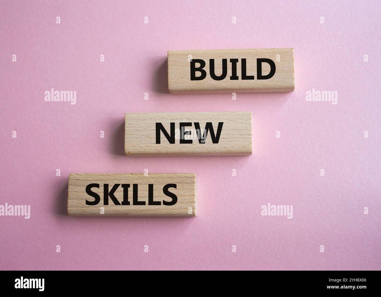 Build New skills symbol. Concept word Build New skills on wooden blocks ...