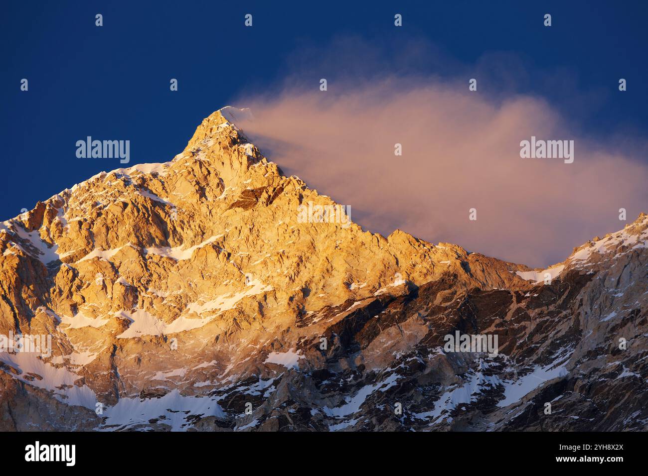 Extreme winds form a banner cloud off the summit of Makalu as sunset ...