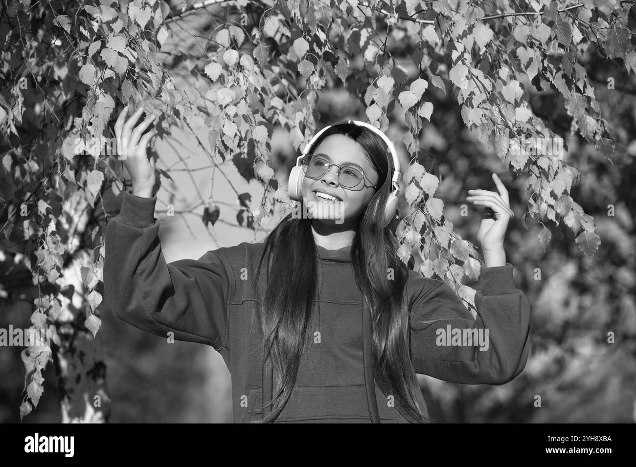 Adolescent girl in fall style. girl in music headphones outdoor. Hello ...