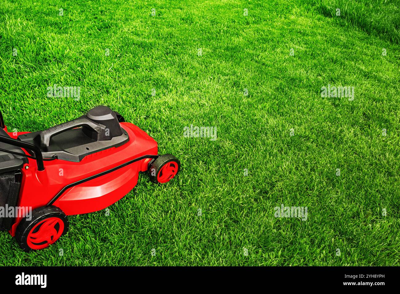 Red lawnmower on the lawn Stock Photo - Alamy