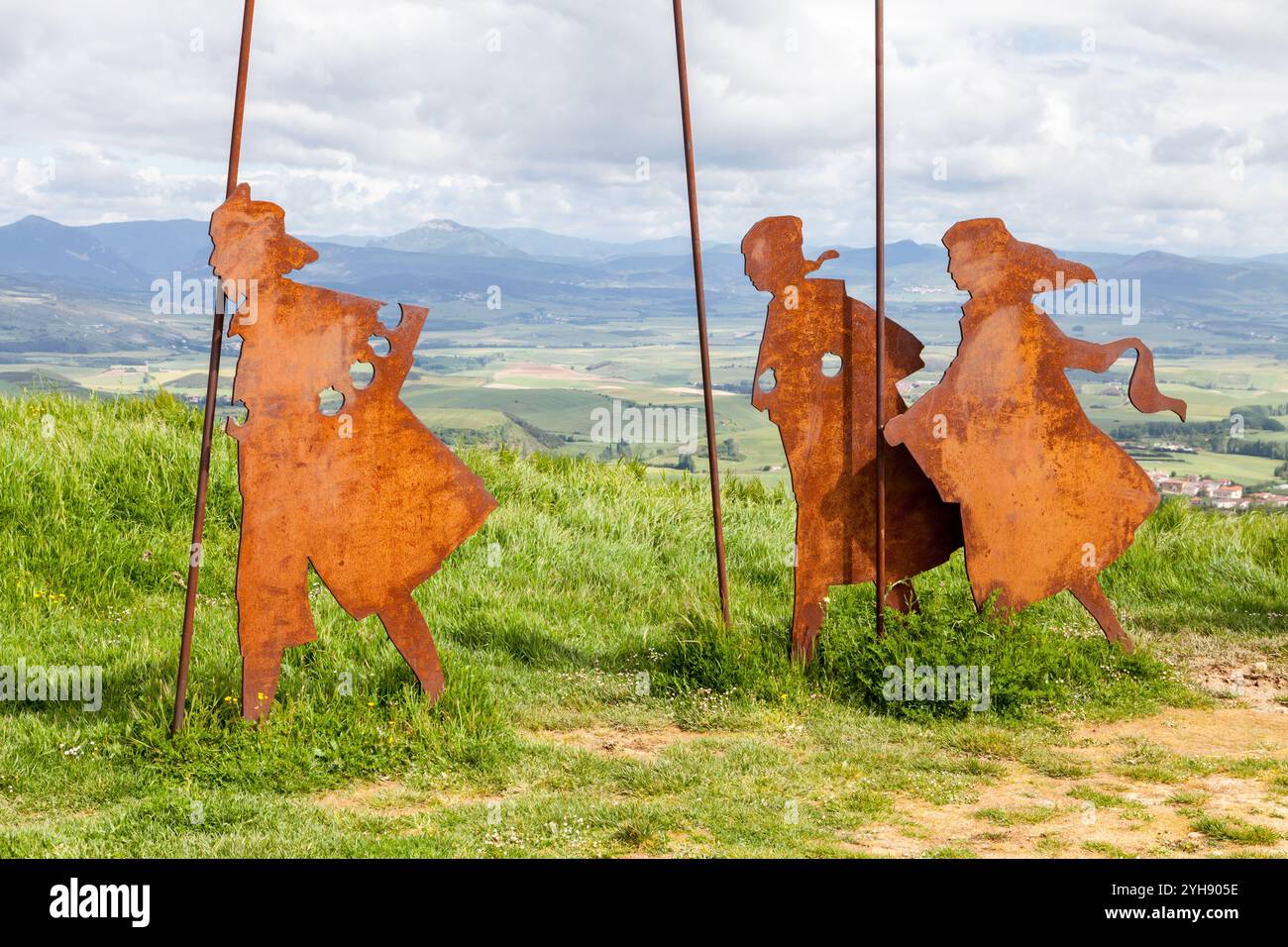 On the Camino de Santiago, metal sculptures of pilgrims walk toward ...