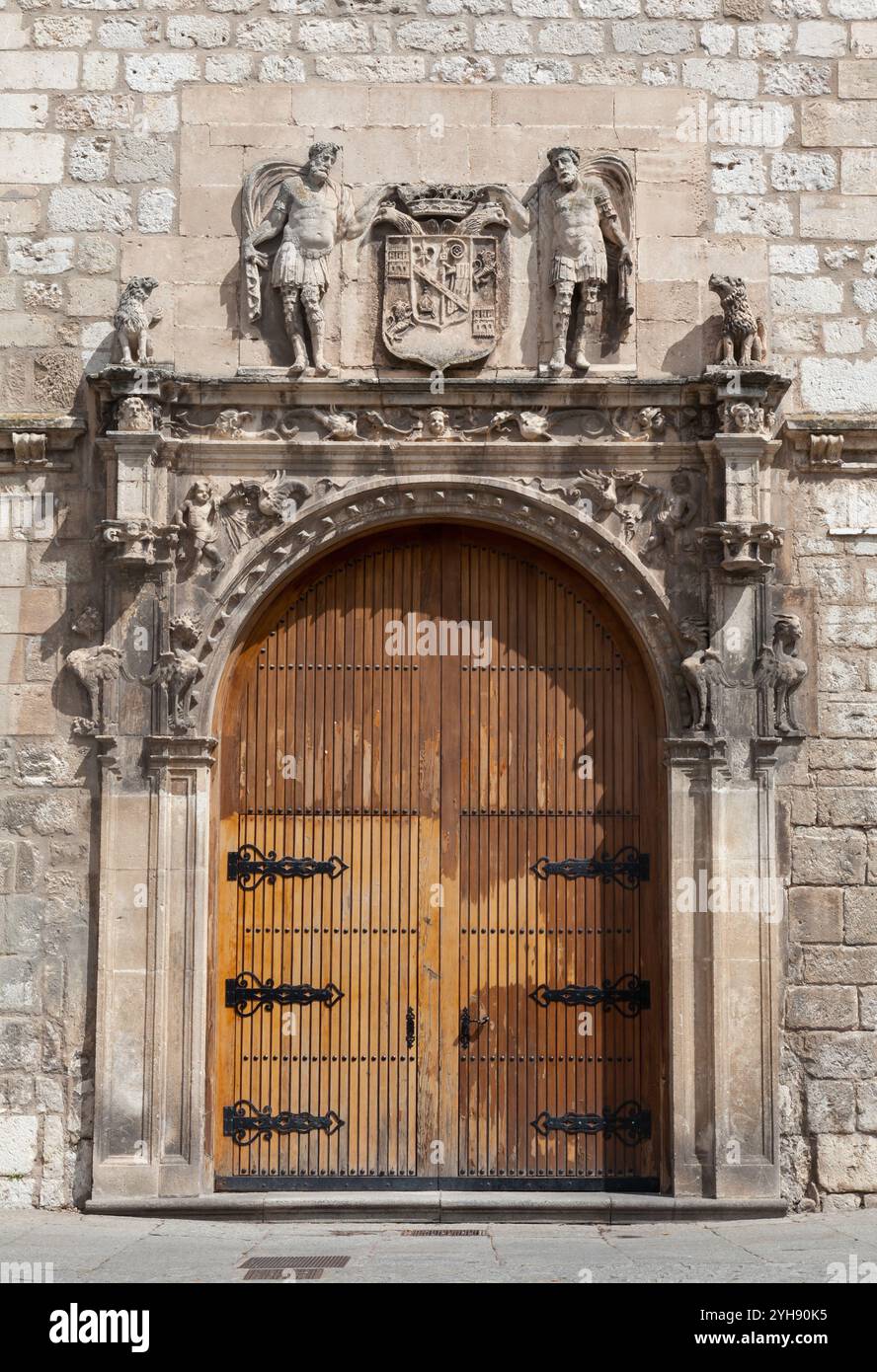 An ornate wooden door featuring intricate stone carvings and sculptures ...