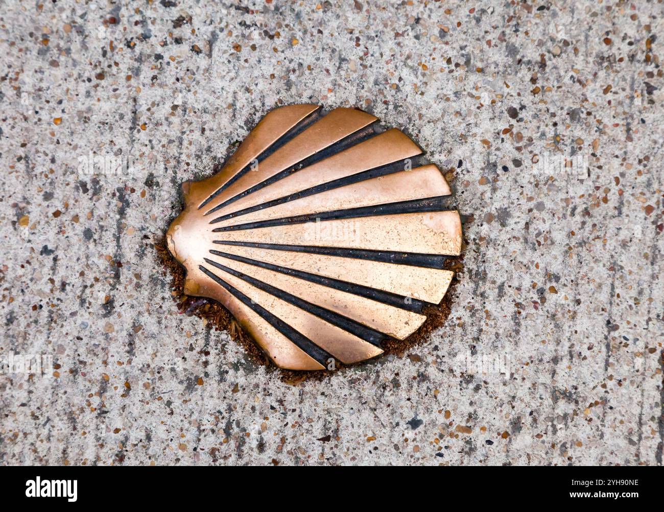 This bronze shell is set into a stone pathway, marking a trail at a ...