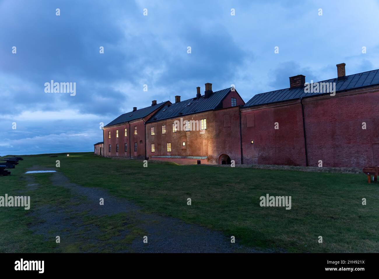 The historic brick buildings stand prominently at dusk, showcasing warm ...