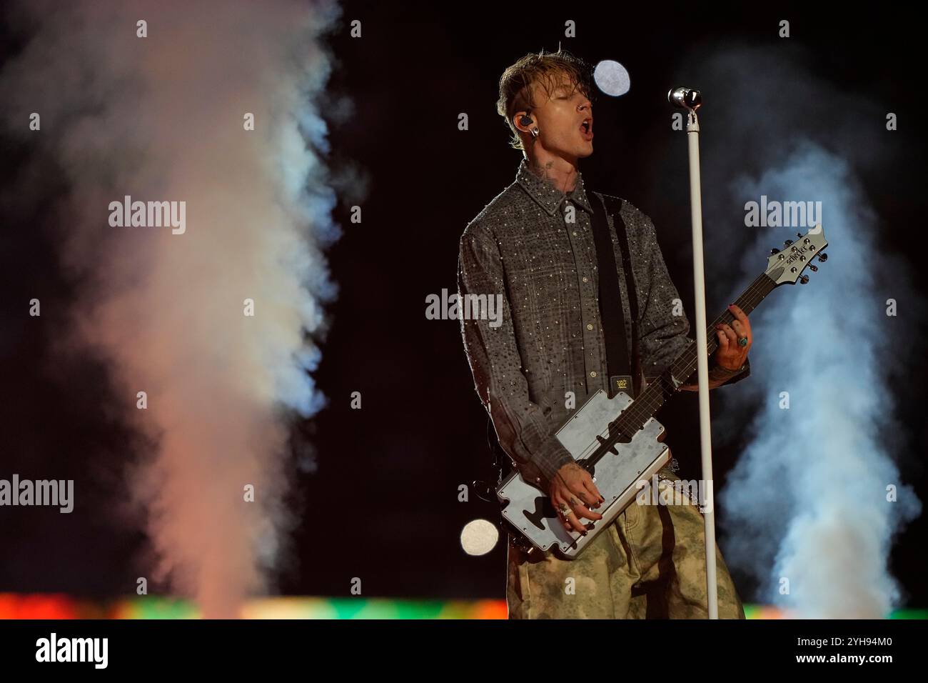 Machine Gun Kelly performs at halftime during an NFL football game ...