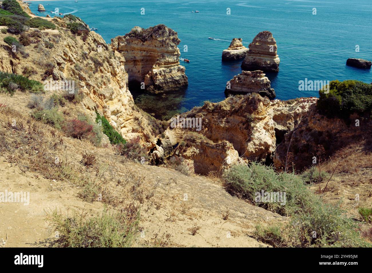 Rock formations rise from the turquoise waters at Ponta da Piedade in ...