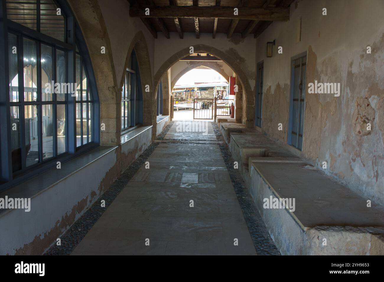 Exploring an ancient corridor adorned with charming arches, revealing a ...