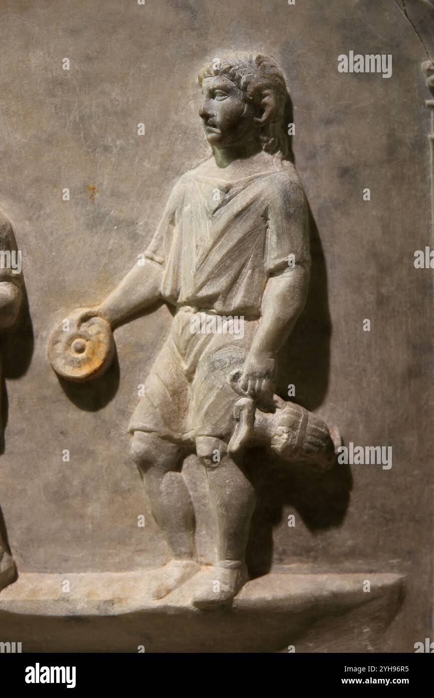 Roman funerary altar. Detail of camilli bearing and parera during ...