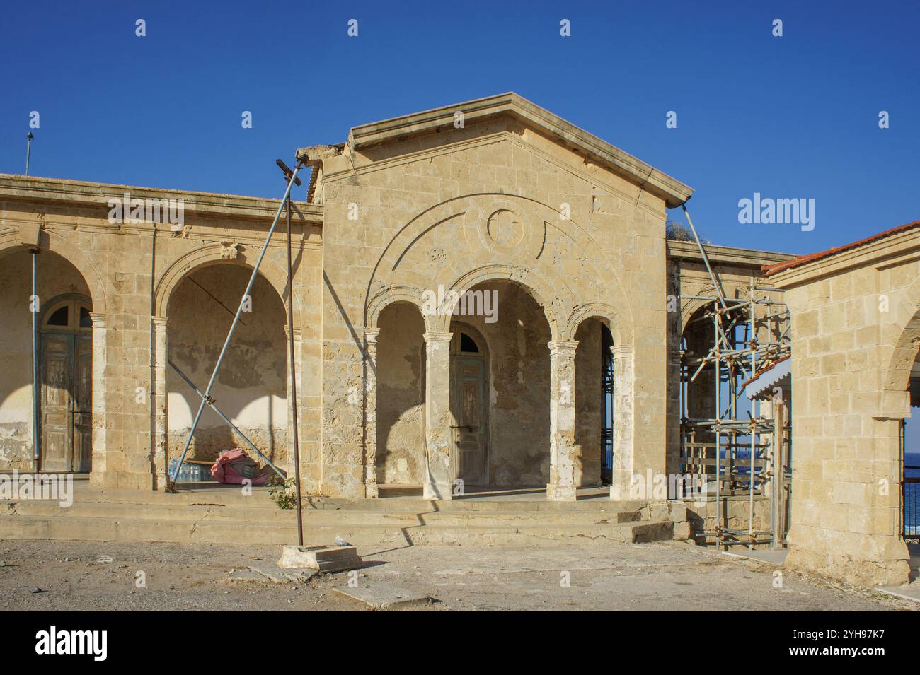 An old stone structure showcases intricate arches, weathered walls, and ...