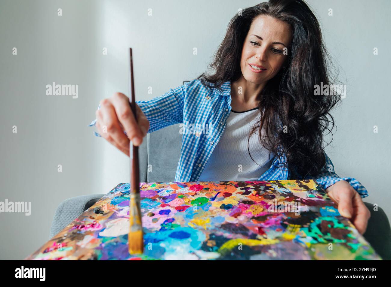 Woman paints with palette brush Stock Photo - Alamy