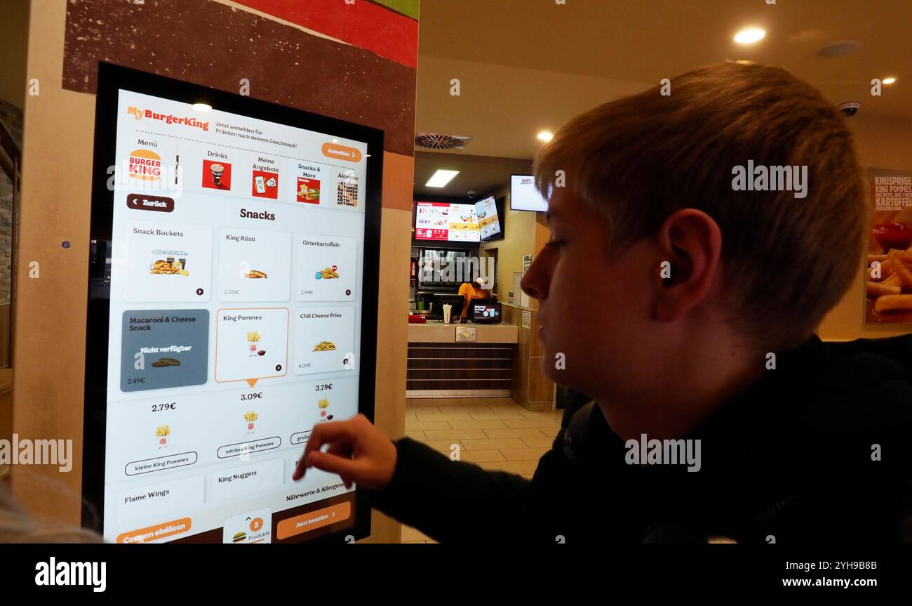 A young man places an order at a display at Burger King Stock Photo - Alamy