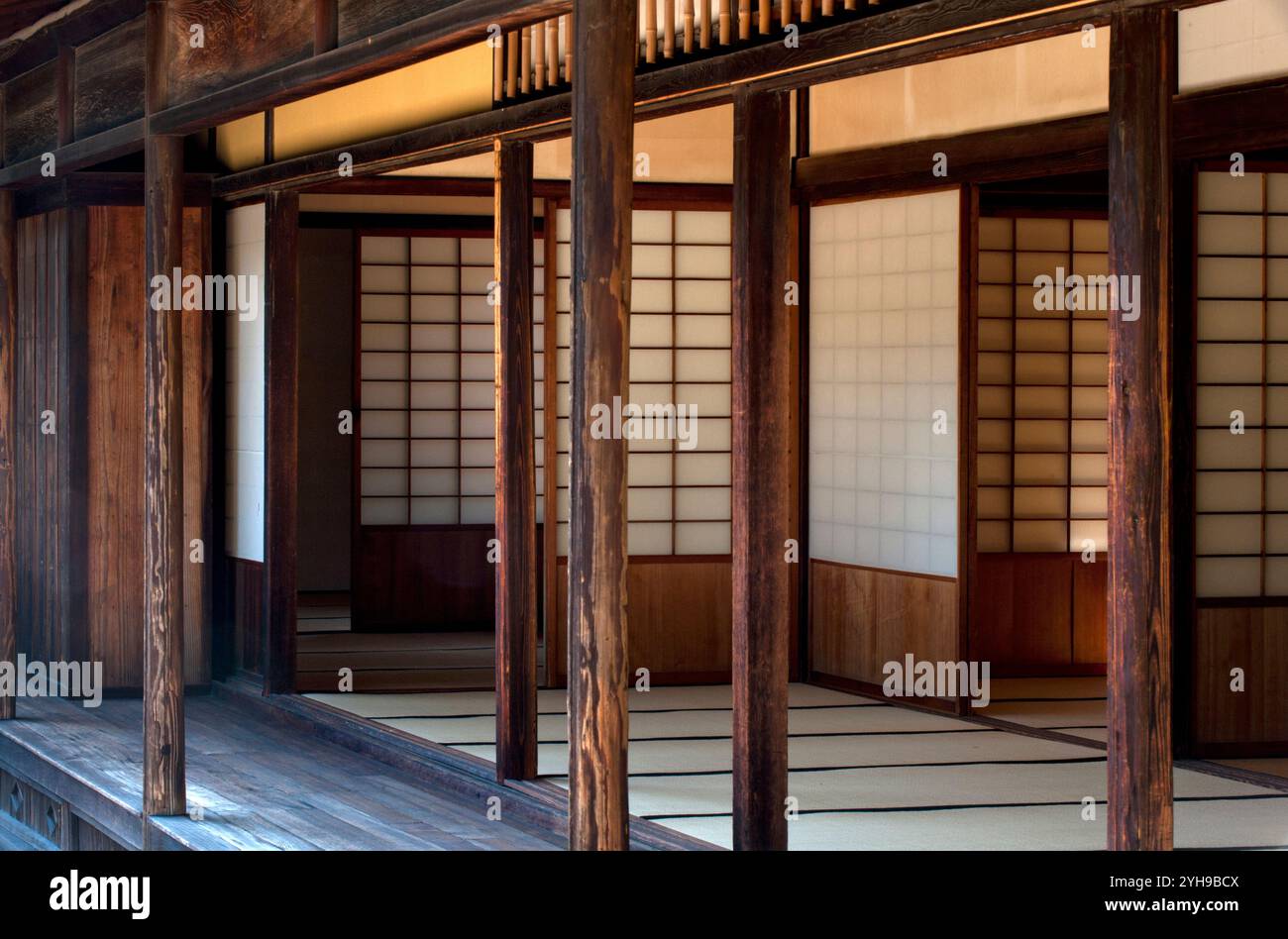 Sliding shoji paper screen panels divide the interior space of the ...