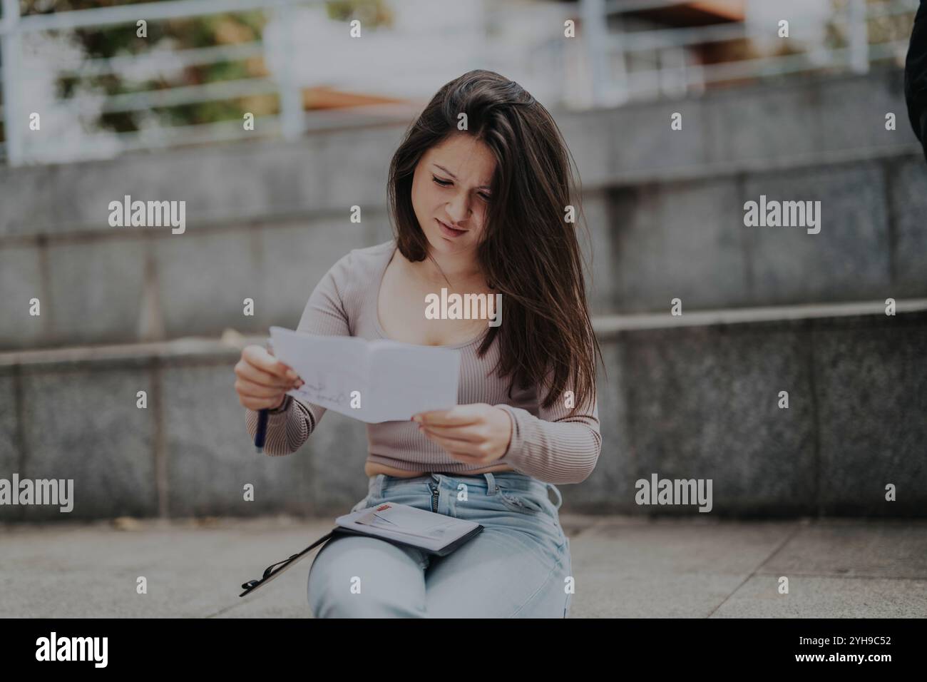 Student studying outdoors in urban setting after classes Stock Photo ...