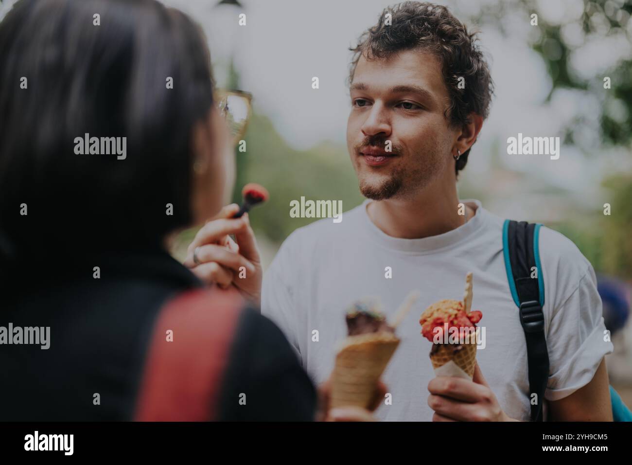 Multicultural students eating ice cream together in a park during break Stock Photo - Alamy