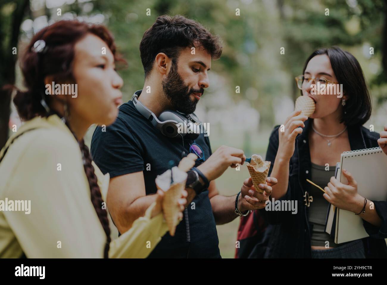 Students enjoy an ice cream break with professor outdoors Stock Photo ...