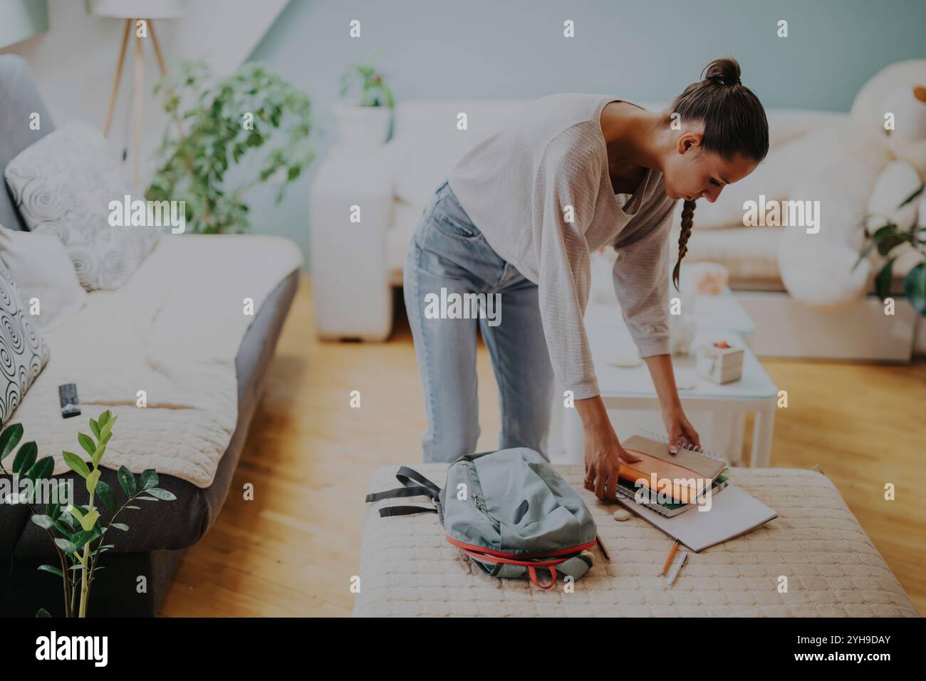Young college student organizing study materials at home Stock Photo ...