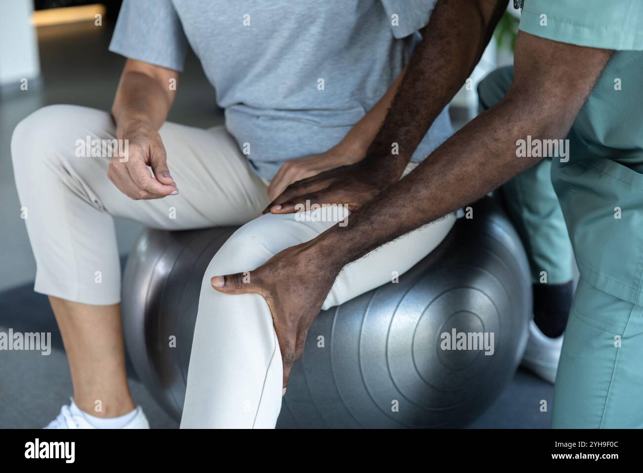African american manual therapist working with a female patient with ...