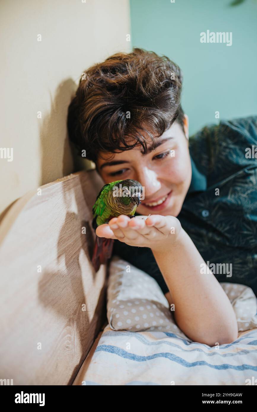 Young woman interacting with a playful parrot on her hand Stock Photo ...