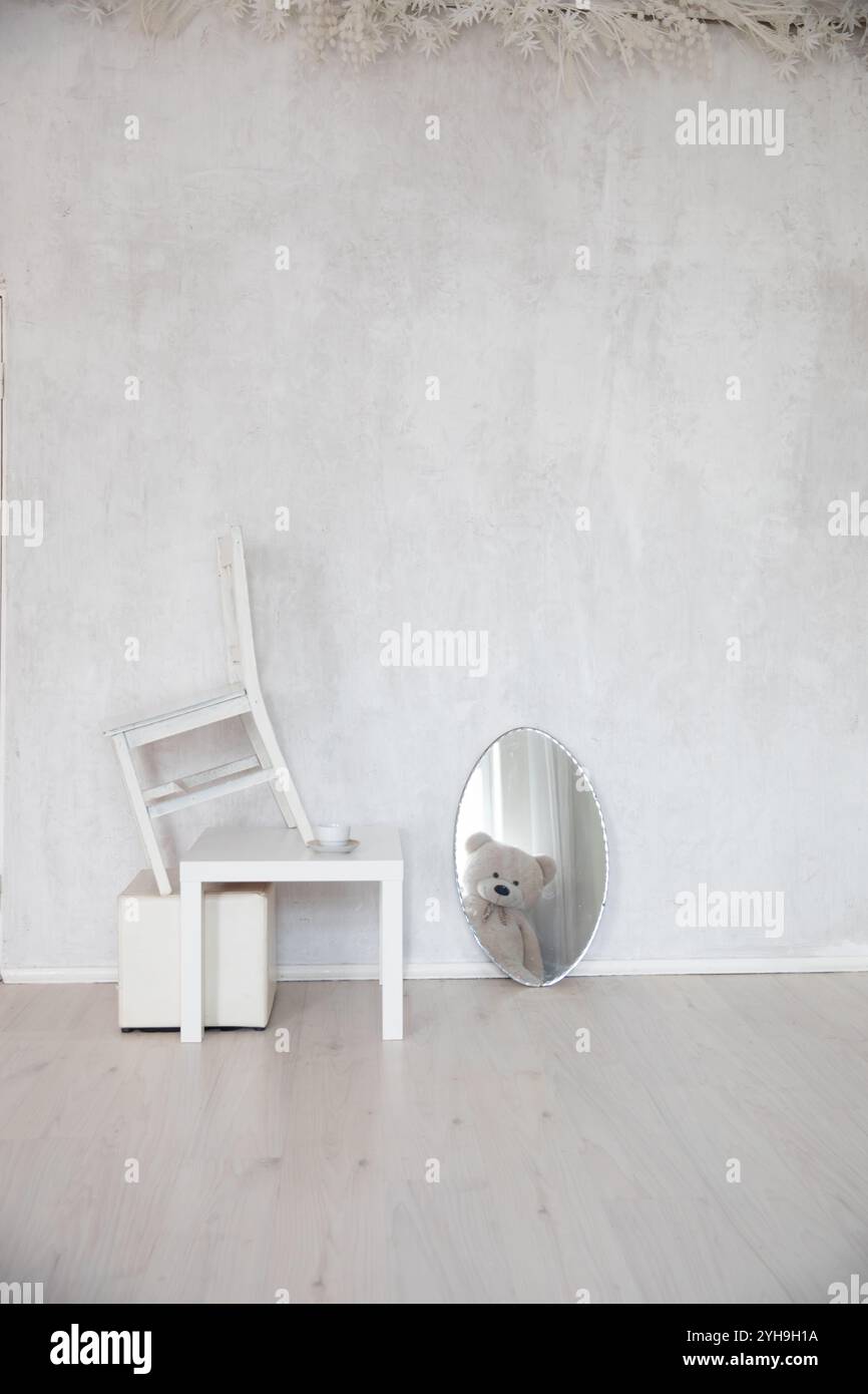vintage mirror chair and table in the interior of an empty white room ...