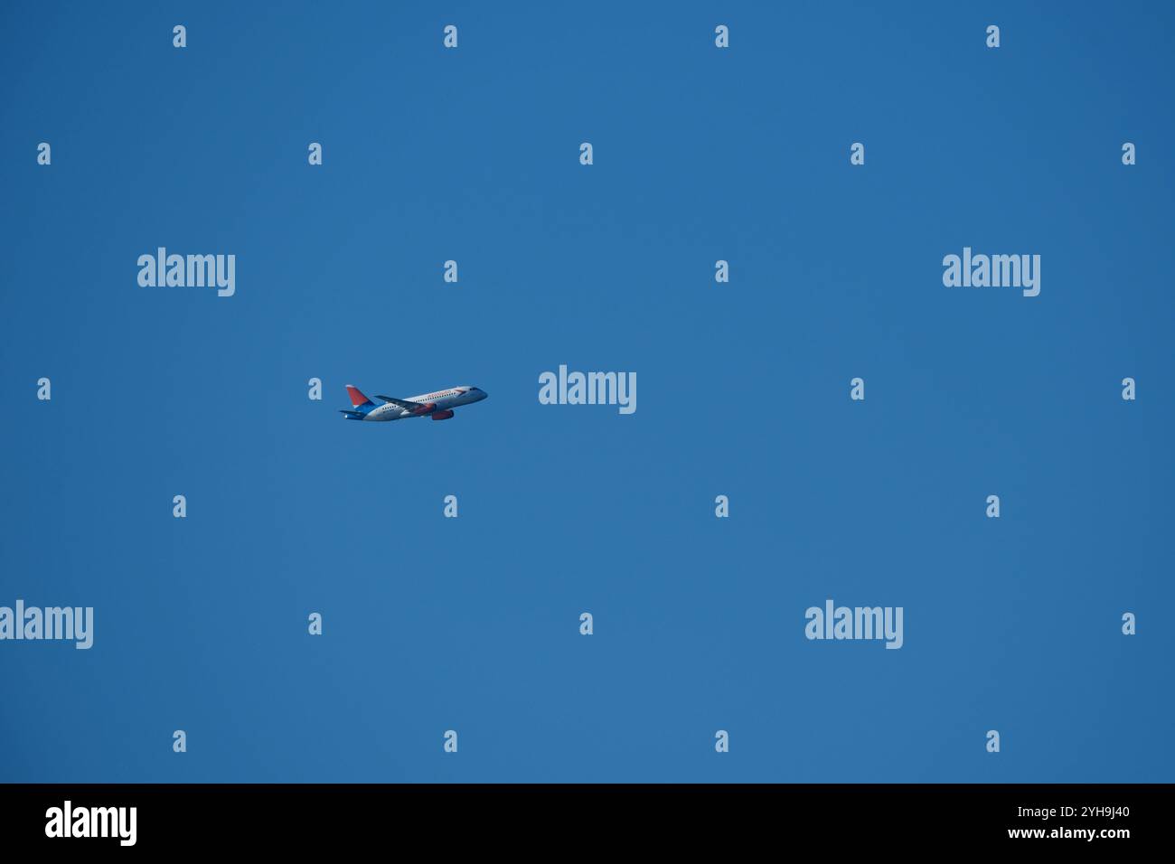 Airplane in the blue sky. Sukhoi Superjet 100. Azimuth Airlines Stock ...