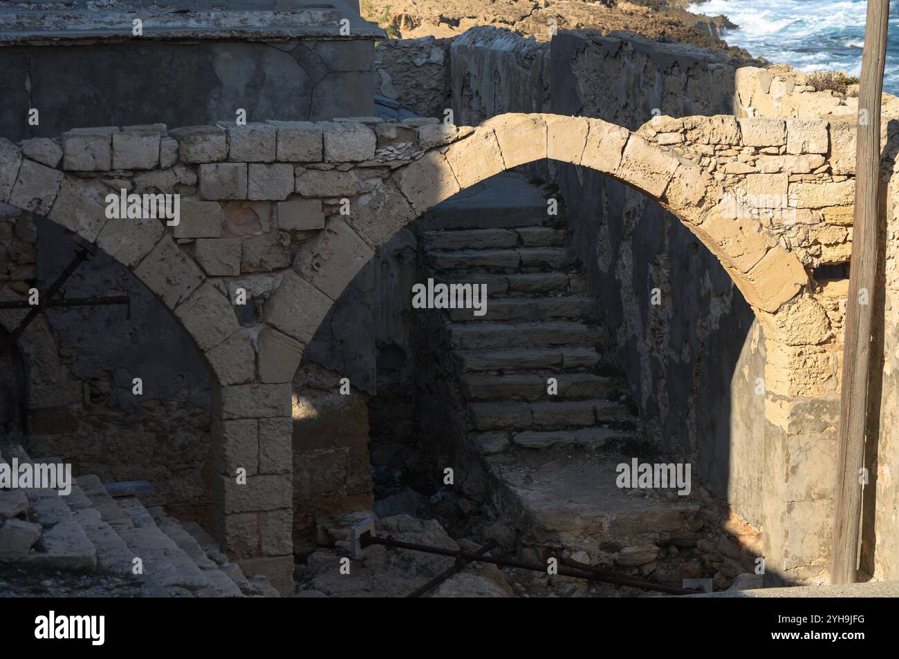 A breathtaking view of weathered stone arches leading to narrow stairs ...