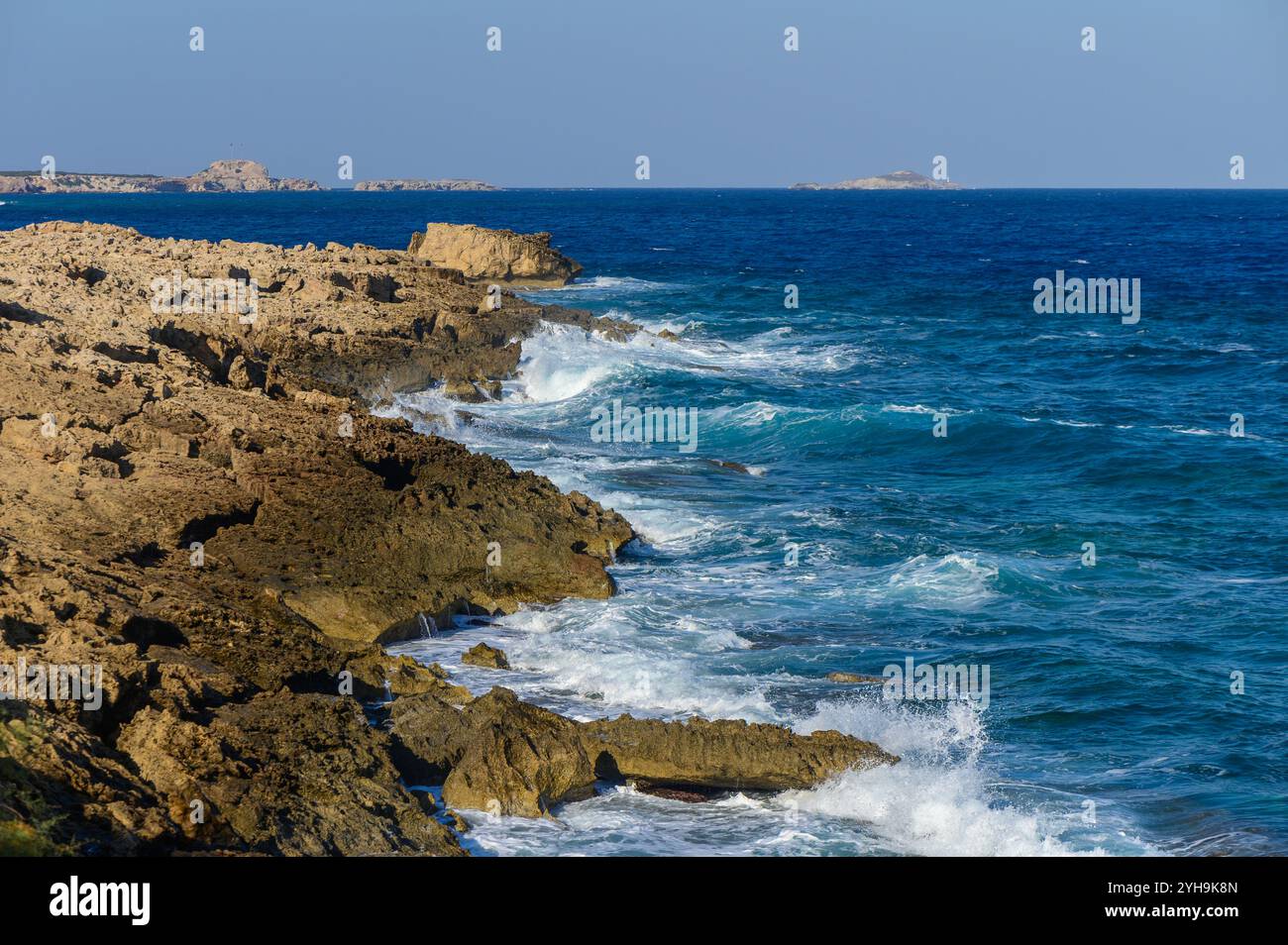 The gentle surf creates a rhythmic melody as waves collide with rugged ...