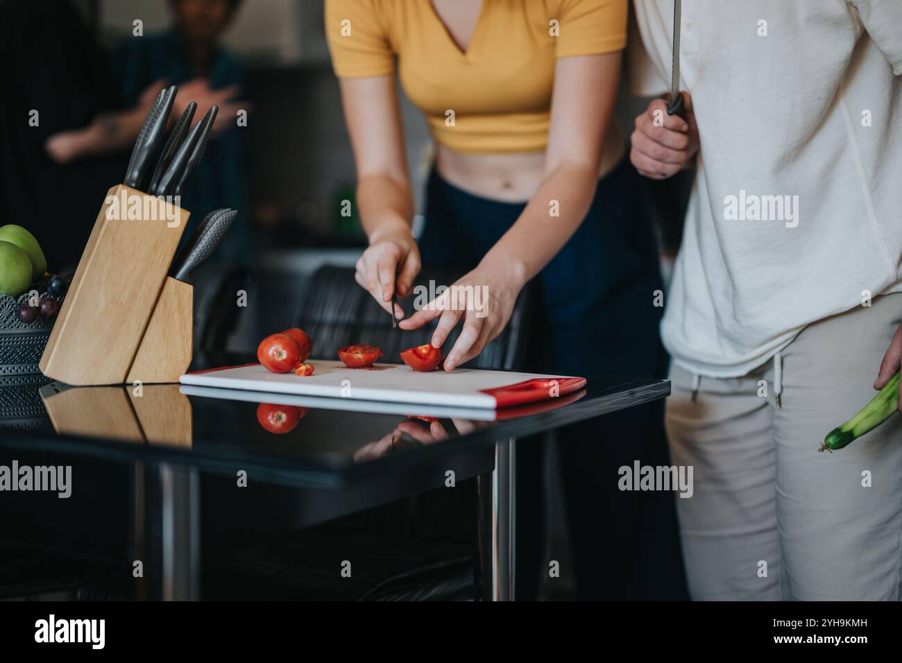 People preparing fresh vegetables in modern kitchen setting Stock Photo ...