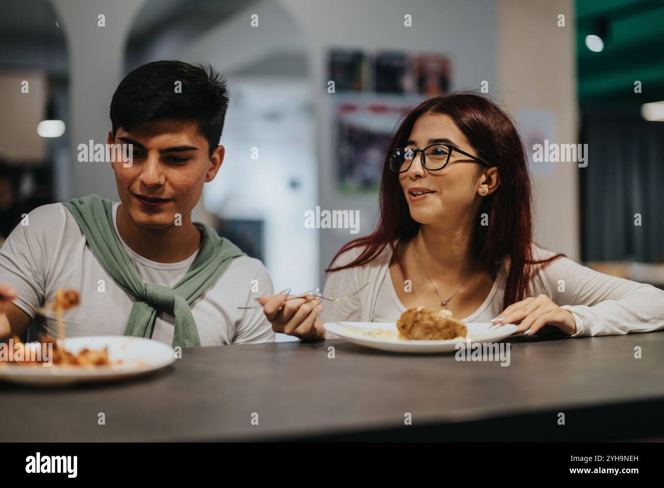 Students enjoying a lively lunch break in the school cafeteria while ...