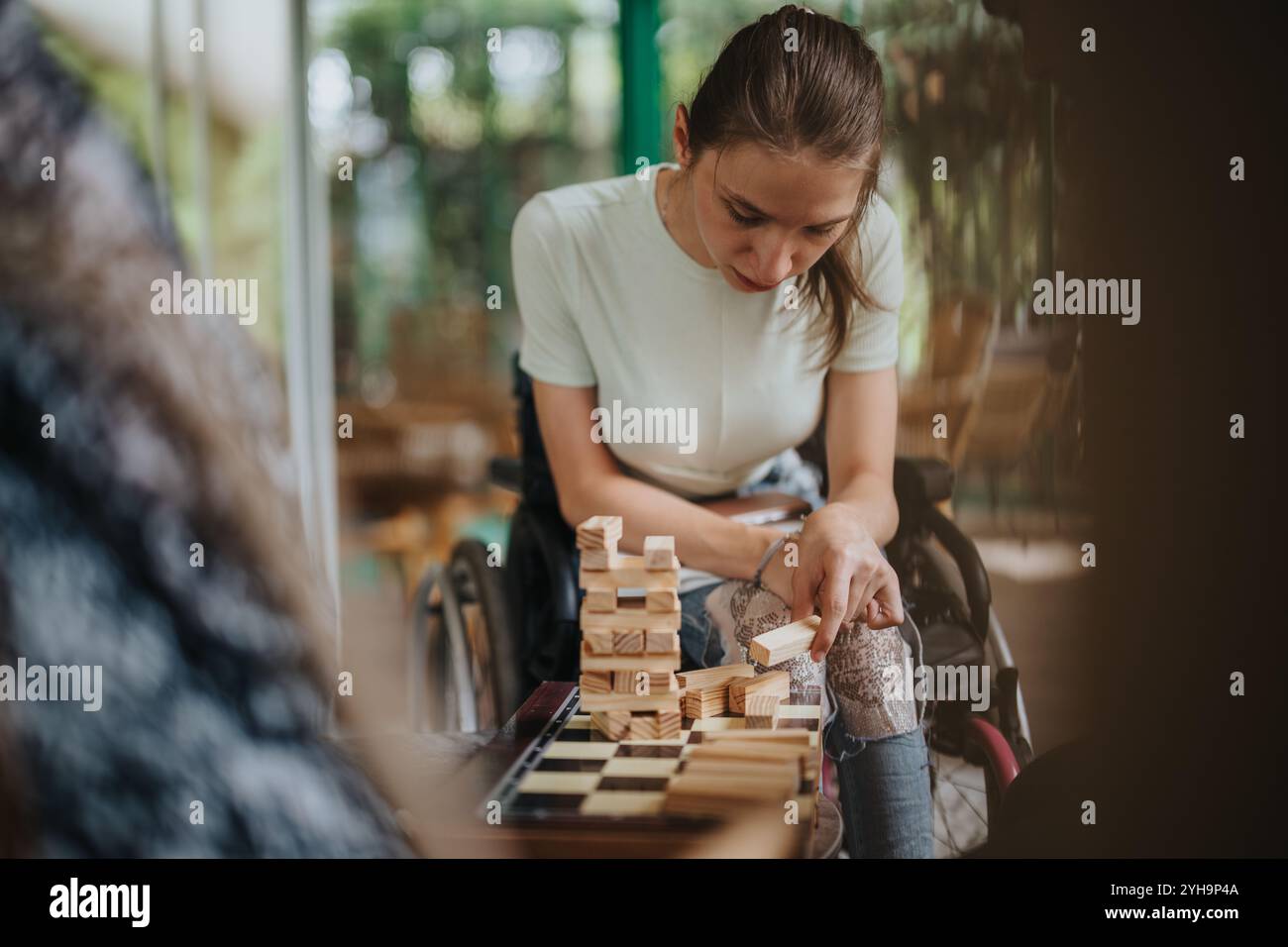 Boy with Down syndrome, girl in wheelchair, and elderly woman playing ...