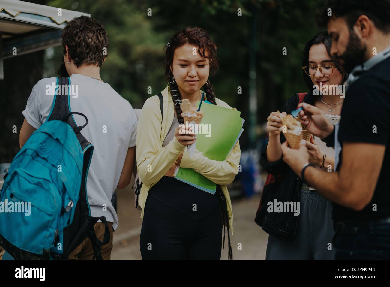Multicultural students enjoying ice cream during a break in the park Stock Photo - Alamy