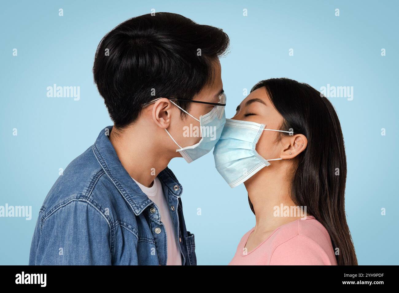 Romantic Young Chinese Couple Kissing In Protective Medical Face Masks ...